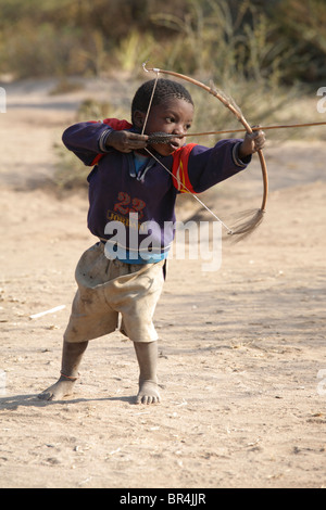 Hadza child practicing archery, Tanzania Stock Photo - Alamy