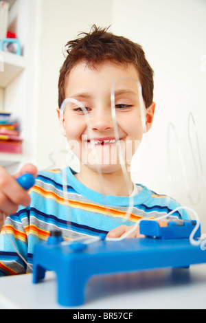 Boy Playing with Wire Coordination Game Stock Photo - Alamy