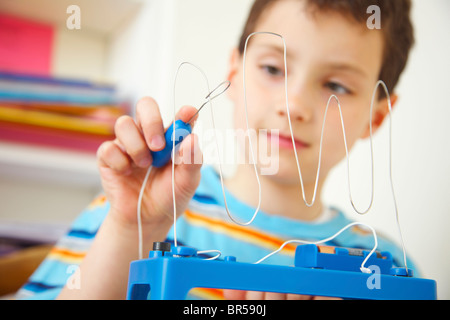 Boy Playing with Wire Coordination Game Stock Photo - Alamy
