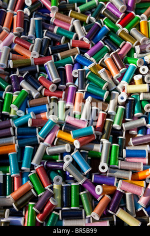 Multicolored cotton reels on display rack Stock Photo - Alamy