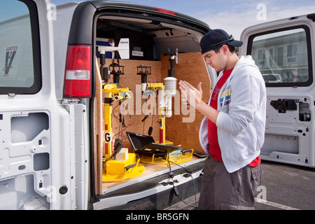 A Vortex 2 storm chaser checks the tornado pods in the back of his ...