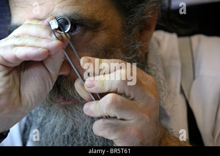 An Orthodox Jewish diamond dealer shows off the quality of one of his ...