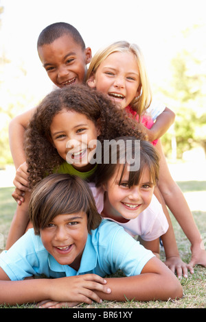 A boy and a girl play in a pile of cut white and gold paper Stock Photo ...