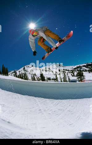 Snowboarder catches air in the half pipe Stock Photo - Alamy