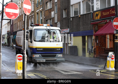 London street cleaner sweep, cleaning streets with brush and spade ...
