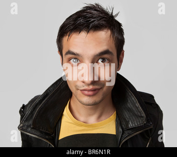Ethnic person wearing a leather jacket and holding a vintage analogue ...