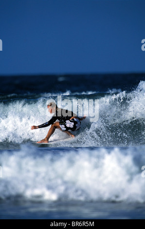 A female surfer surfing on a choppy coastline Stock Photo - Alamy