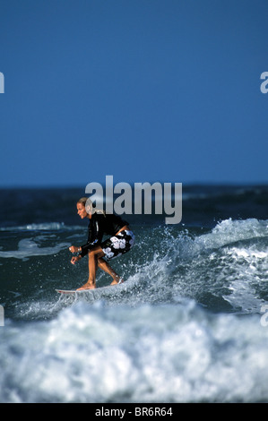 A female surfer surfing on a choppy coastline Stock Photo - Alamy