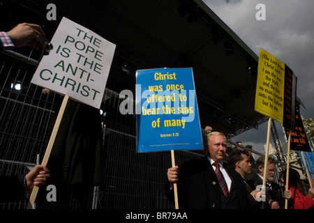 Anti-Papal protesters hold placards during Pope Benedict XVI's papal ...