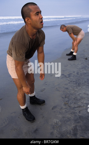 Man hunched over on the beach after running in San Diego California ...