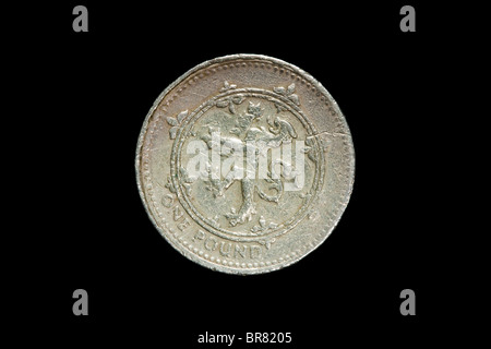 The reverse, or 'tail's' side, of a fake British £1 coin (left) along ...