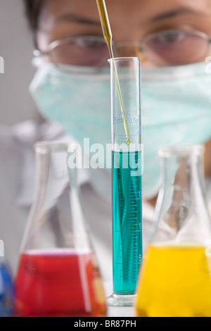 Mixing carefully chemical solution into the test tube Stock Photo - Alamy