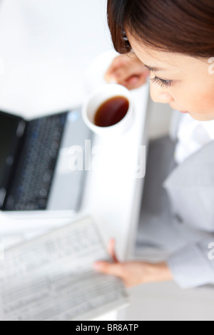 Overhead view of businesswoman holding coffee cup at hotel lobby Stock ...