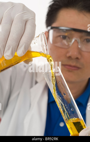 Scientist pouring chemicals Stock Photo: 28757997 - Alamy