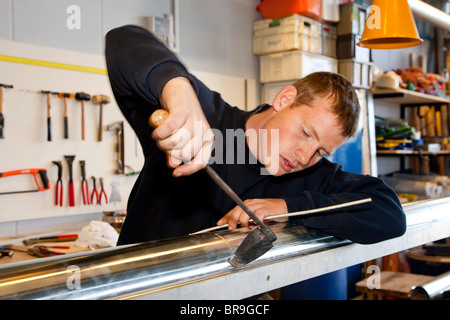 Young plumber making a gutter at the workshop Stock Photo: 31557909 - Alamy