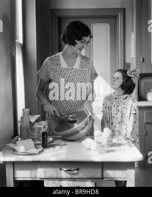 1920s 1930s WOMAN IN KITCHEN WORKING COOKING ON STOVE Stock Photo - Alamy