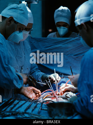 1970 1970s RETRO MAN DOCTOR USING STETHOSCOPE TO CHECK BLOOD PRESSURE ...