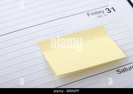 blank post-it note stuck into a diary at the end of the month Stock ...