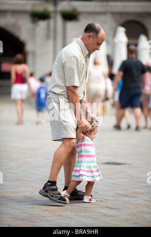 Parents teach children how to walk, hold objects, take turns, play ...