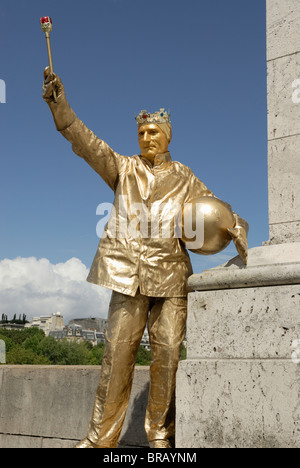 Blue painted man street performer, human statue, sitting still at a ...