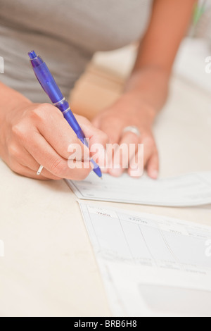 Close up of a pen and cheque. Writing a cheque Stock Photo - Alamy