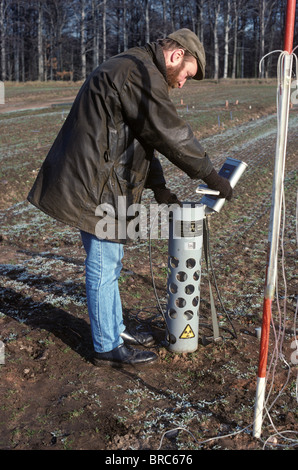 Scientist using a neutron probe to detect subterranean water Stock ...