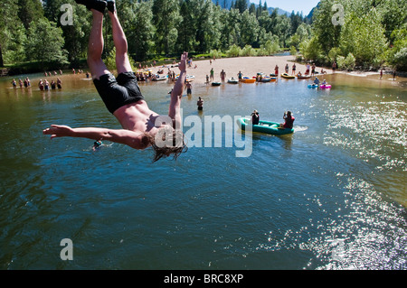 Tourists swimming in the Merced River in Yosemite National Park ...