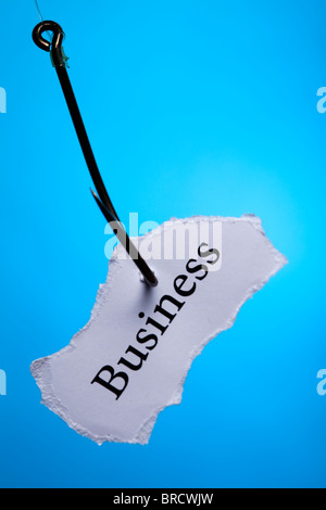 Business on peace of paper pierced in hook Stock Photo - Alamy