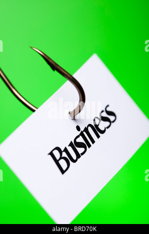 Business on peace of paper pierced in hook Stock Photo - Alamy