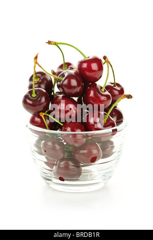 White cup full of fresh cherries on pastel blue concrete background ...