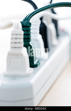 Many plugs plugged into electric power bar close-up Stock Photo - Alamy