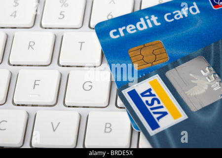 Credit cards with computer keyboard on grunge background, closeup ...