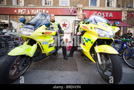 NHS ambulance motorcycle riders parked up outside Liverpool Street ...