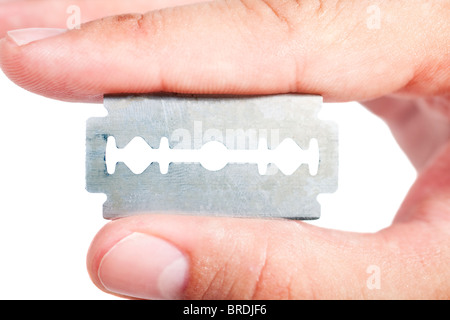 Hand holding a razor blade on a white background Stock Photo - Alamy