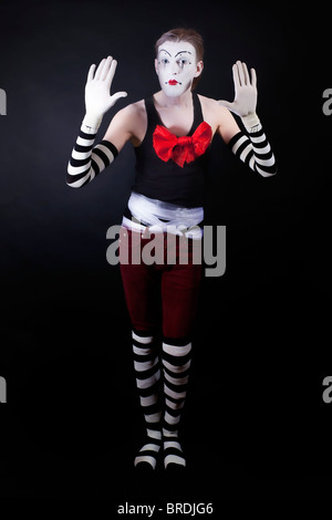 Mime with a big red bow on a black background Stock Photo - Alamy