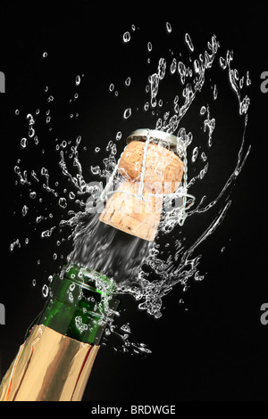 Close-up of liquid and a cork exploding out of a long neck bottle Stock ...