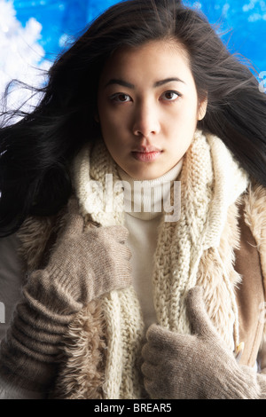 Young asian woman wearing winter sweater over isolated background ...
