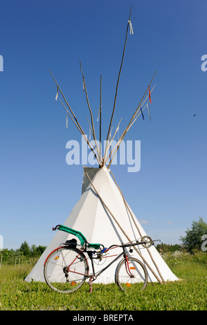 Germany, eco village Siebenlinden , red indian tipi tent and laying ...