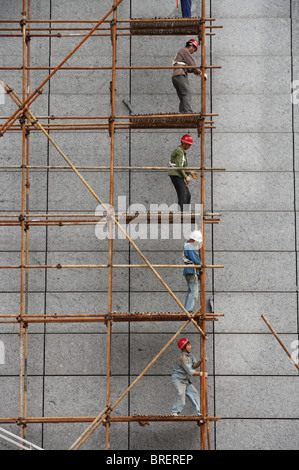 Workers constructing scaffolding in the Pudong District of Shanghai ...