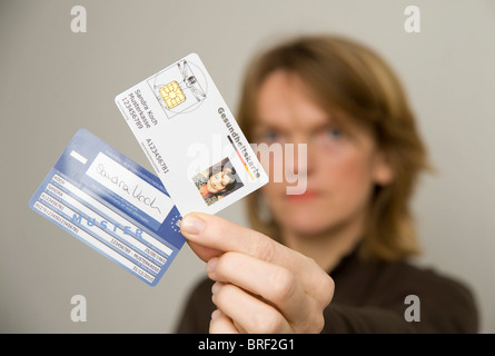Woman holding a German electronic health insurance card Stock Photo - Alamy