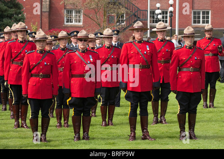 Royal Canadian Mounted Police officers parade in ceremonial red serge ...