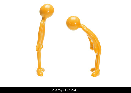 Toy rubber figurine bowing to another on white background Stock Photo ...