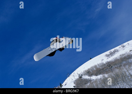 Male snowboarder flying through the air Stock Photo - Alamy