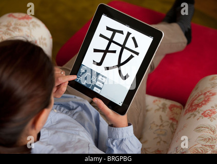 Female student learning mandarin Chinese using education application on ...