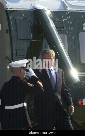 President George W. Bush salutes a marine before crossing the South ...