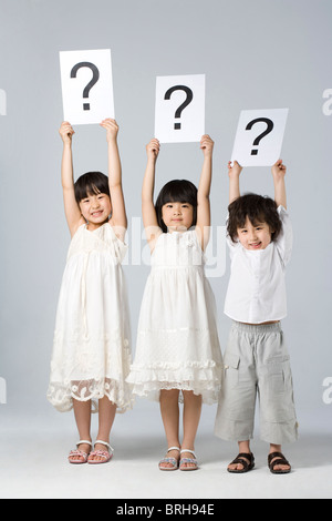 Children holding signs with question marks Stock Photo - Alamy