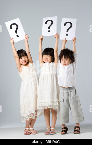 Children holding signs with question marks Stock Photo - Alamy