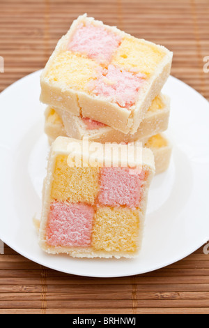 Battenberg cake or Battenberg square a sponge with pink a yellow checks ...