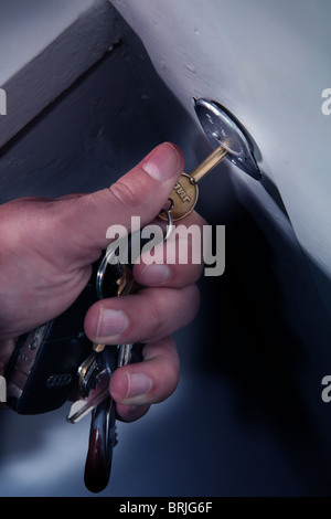 Man locking / unlocking front door of property Stock Photo - Alamy