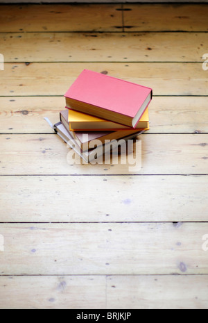 Books stacked on floor Stock Photo - Alamy